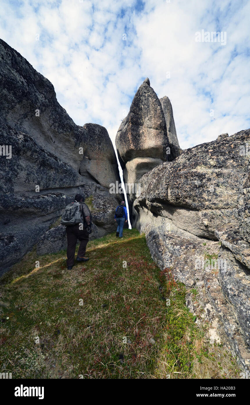 Visitors hike among the tors in Bering Land Bridge National Preserve ...