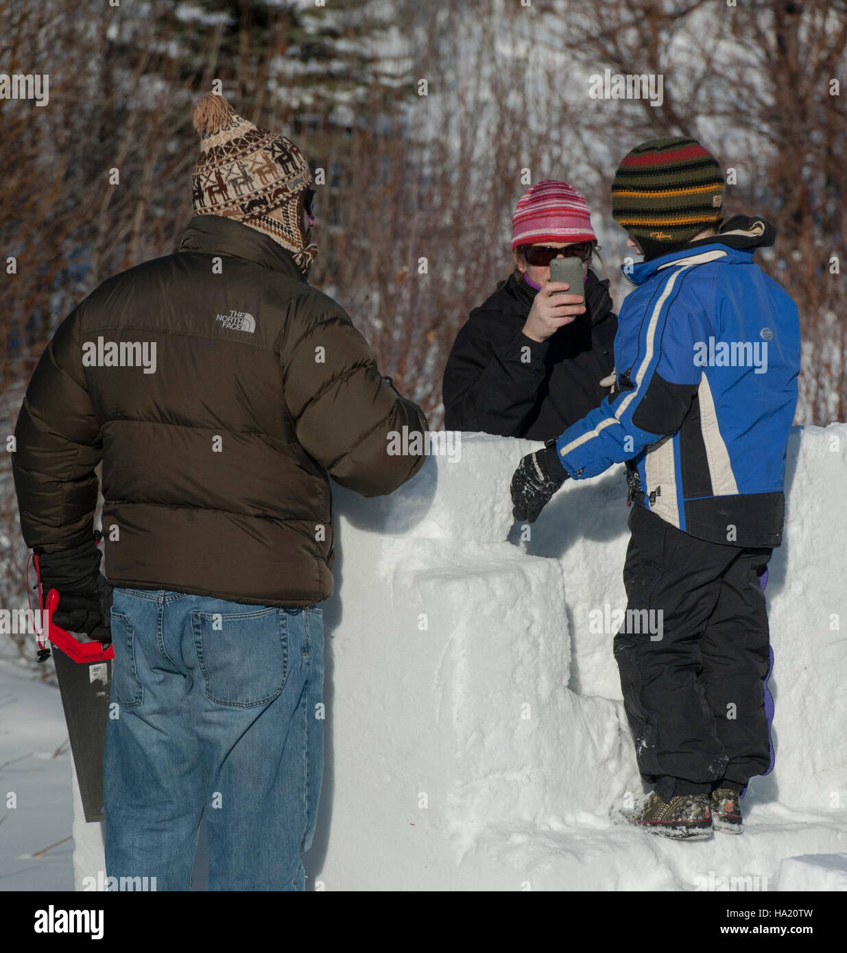 A visitor photographs a family at Denali National Park, capturing the ...
