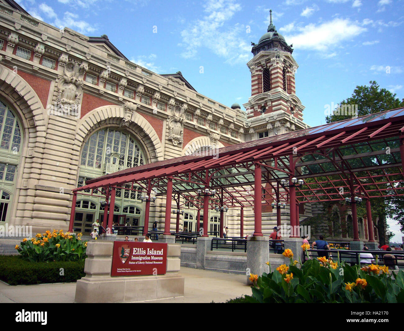 This image of Ellis Island features a canopy and sign, representing the ...