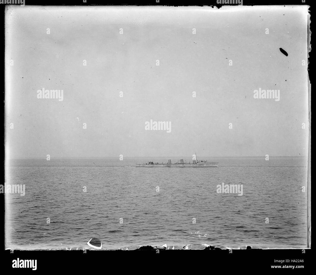A historical image of a naval three-stack vessel in motion, taken ...