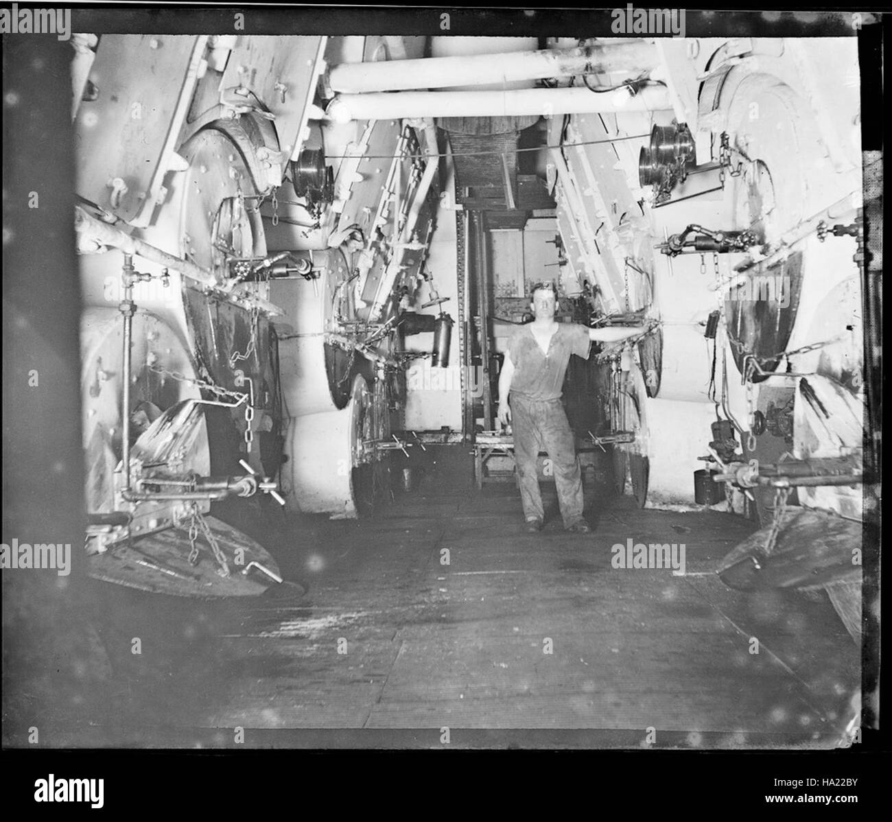 A crew member poses in the engine room of the Manoa, a merchant vessel ...