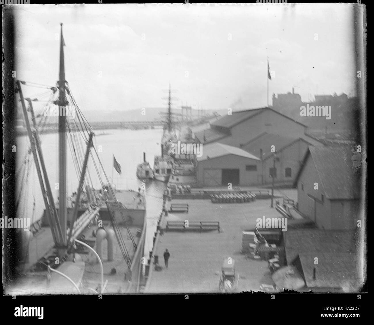This image shows a historic waterfront scene from the early 20th ...