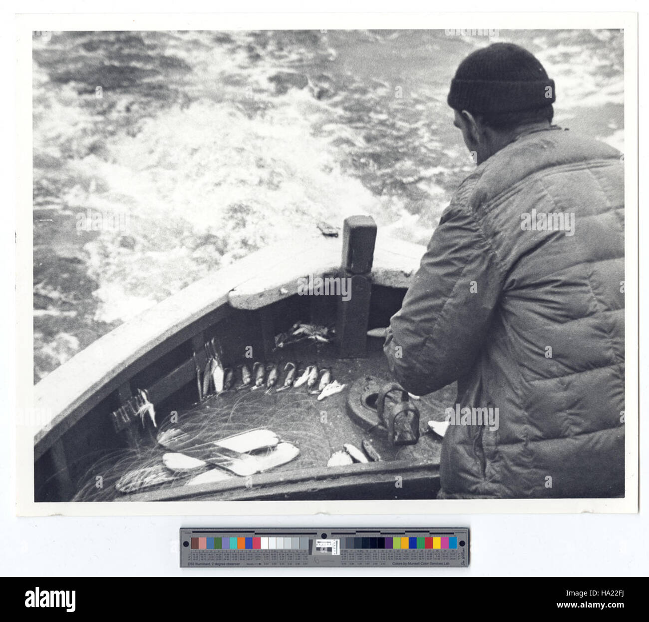 A fisherman prepares fishing lines aboard the Monterey Clipper, a ...