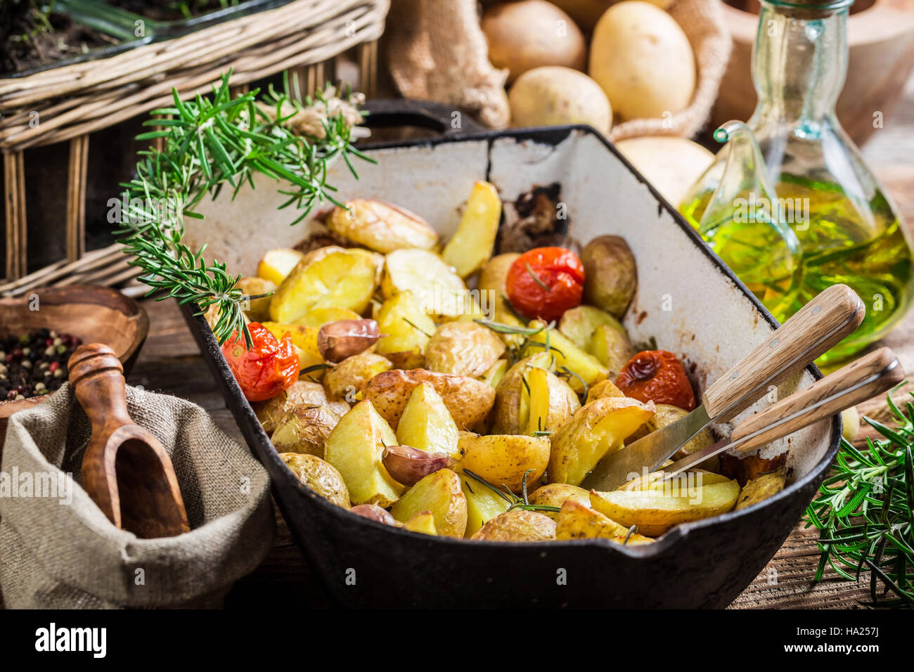 A plate of roasted potatoes with tomatoes is served on a decorative ...