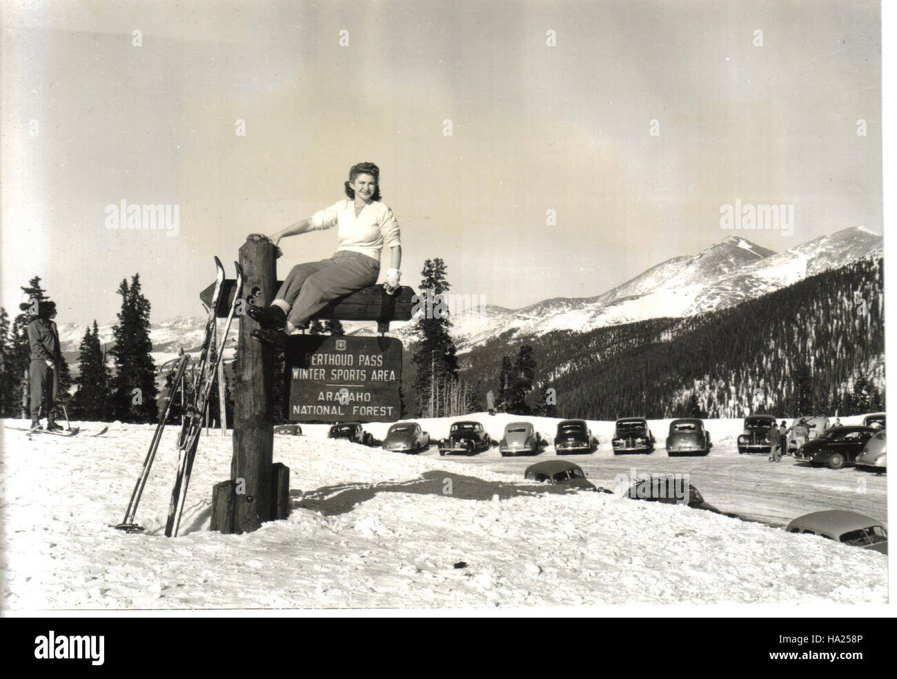A woman poses atop a U.S. Forest Service sign, symbolizing the ...