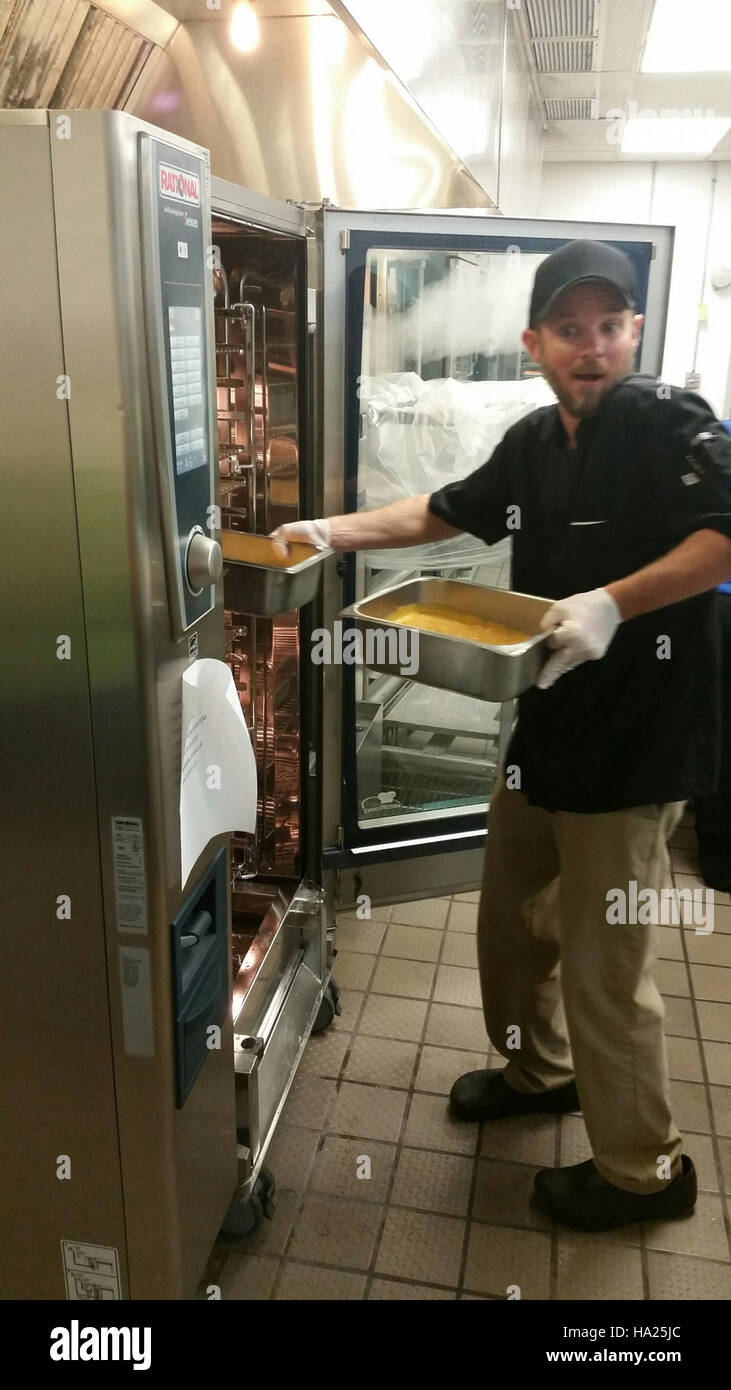 usdagov 20303897483 Flowing Wells employee using the oven unit Stock ...