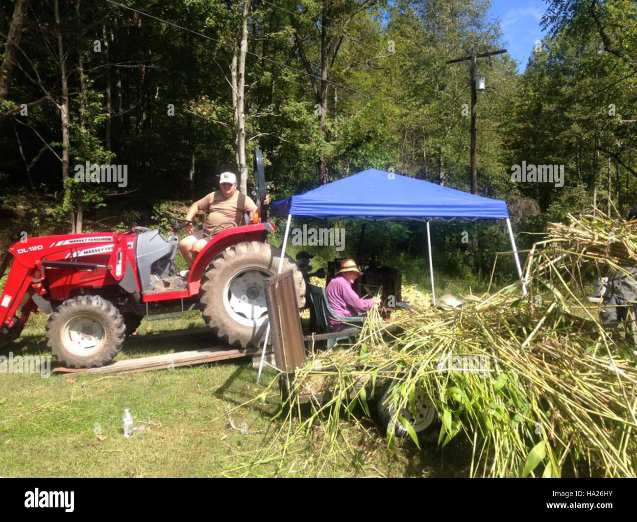 A photo of Eric Grandon standing by a tractor and a tent, illustrating ...