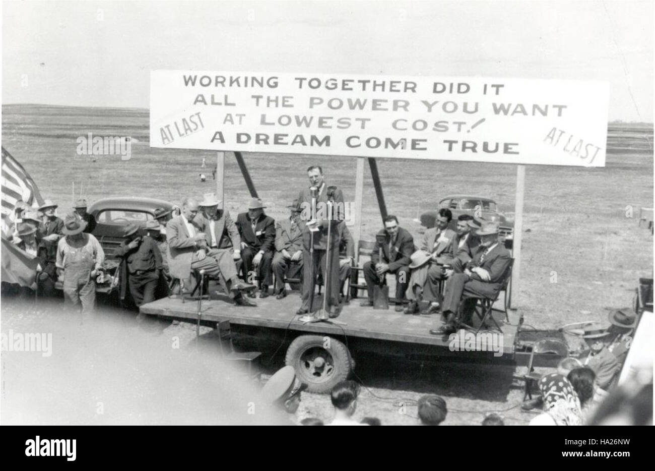 A group of volunteers holds a 'Working Together' sign at a national ...