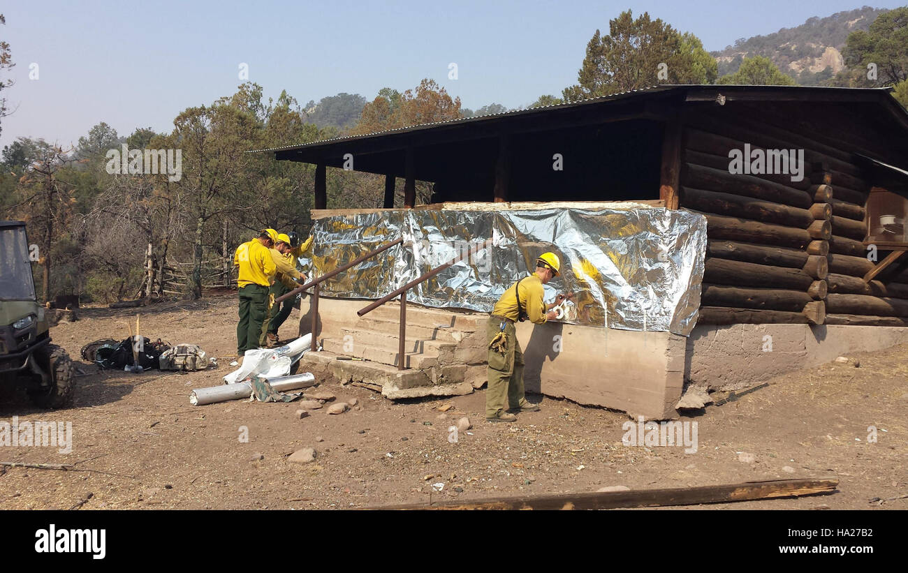 A cabin wrap made from aluminized material is used by firefighters ...