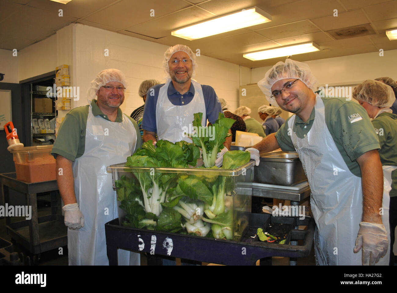 The image showcases food preparation at the USDA Central Kitchen ...