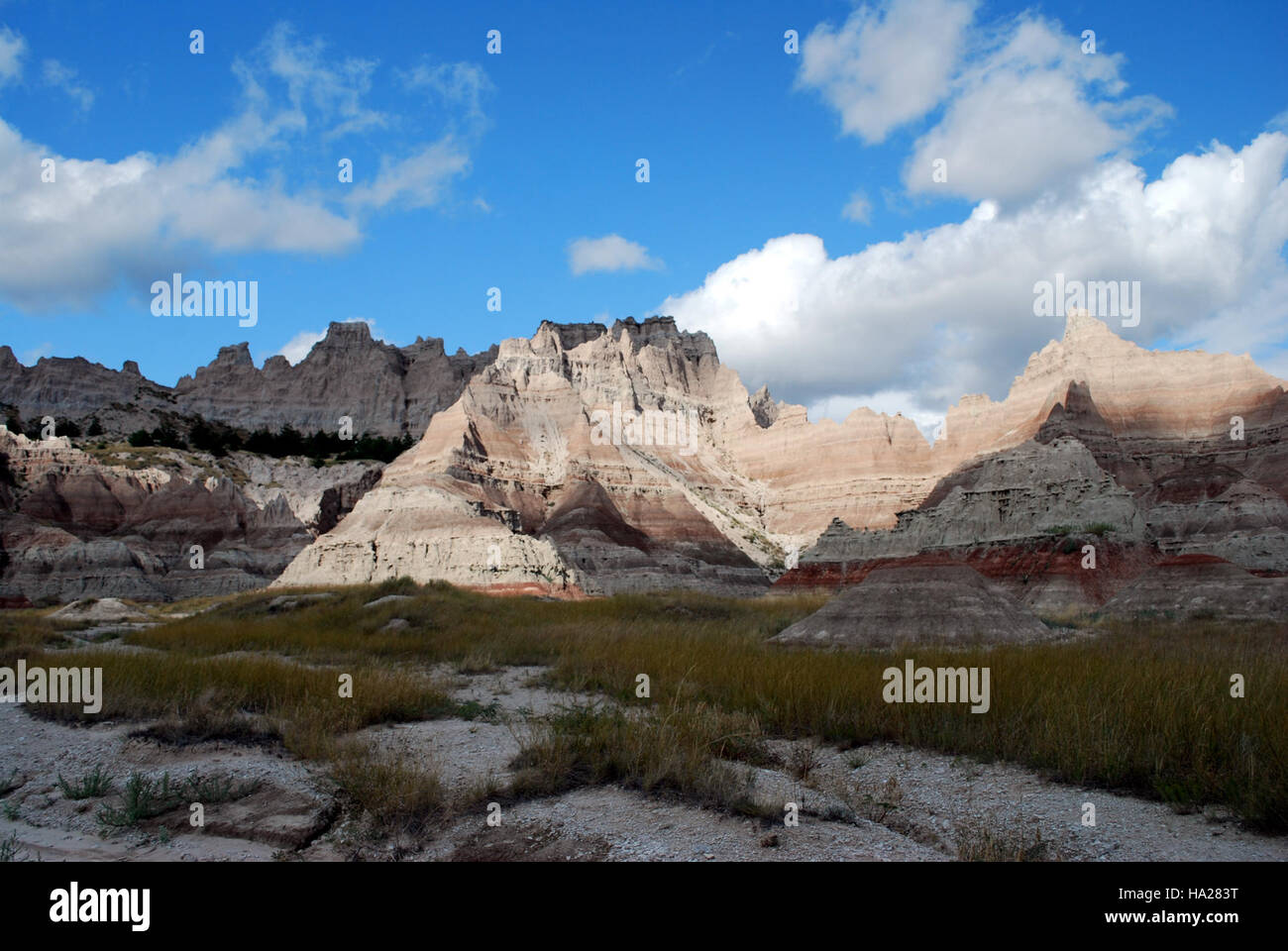 The shadows cast over the rugged terrain of Badlands National Park ...