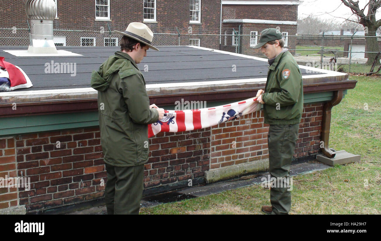 The US Coast Guard Ensign is folded during a ceremony at Governors ...