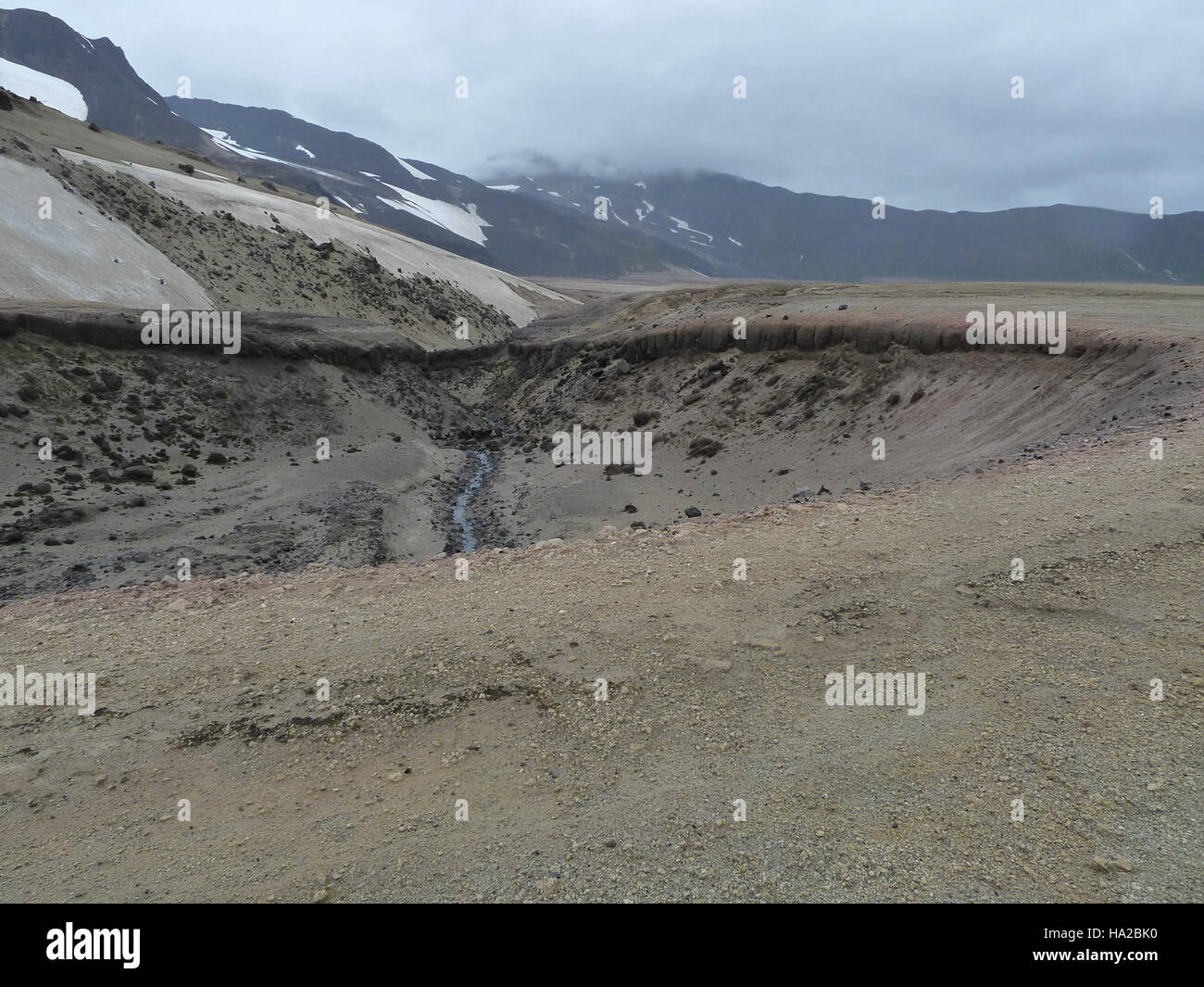 This image shows a phreatic explosion crater adjacent to a lava flow ...