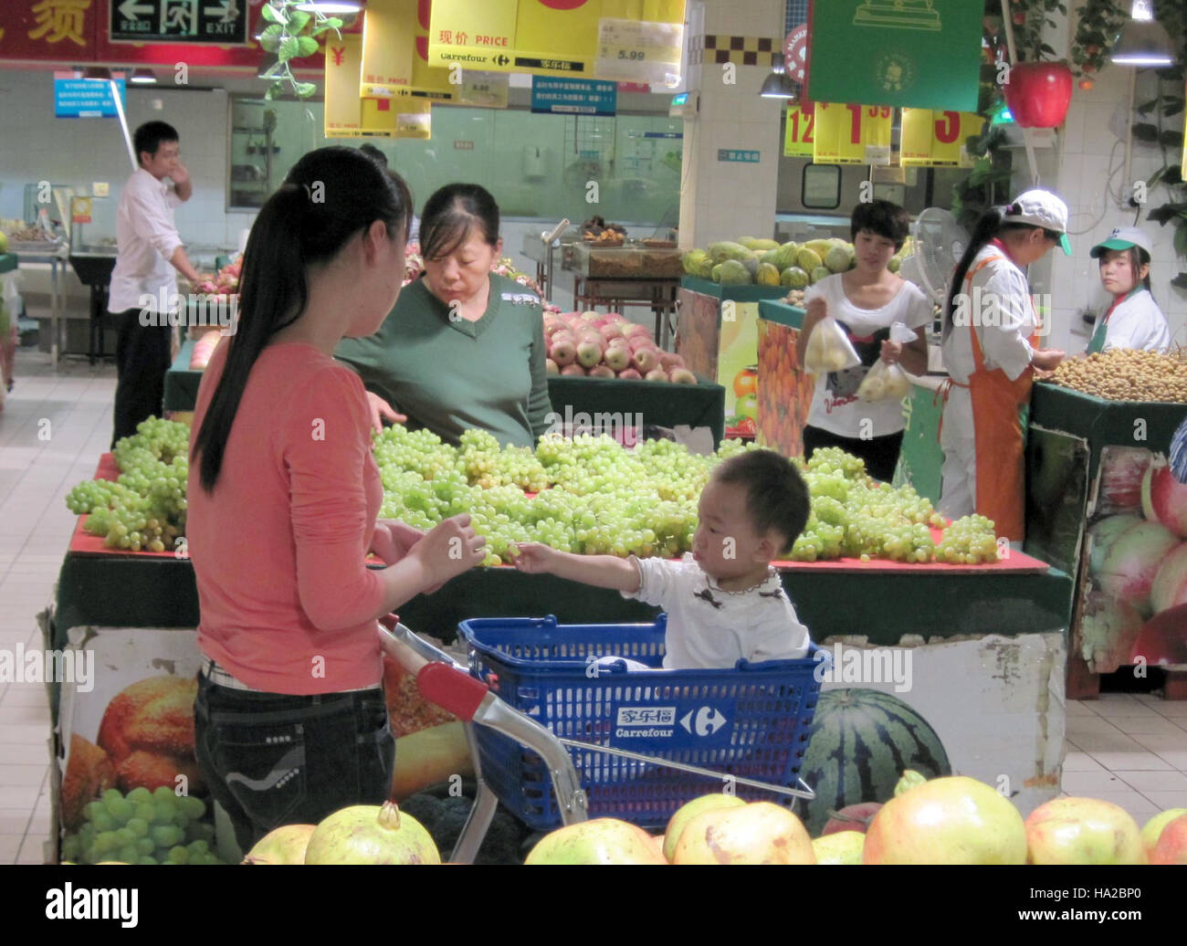 Shoppers in Zhengzhou, China, are seen examining fresh produce in a ...