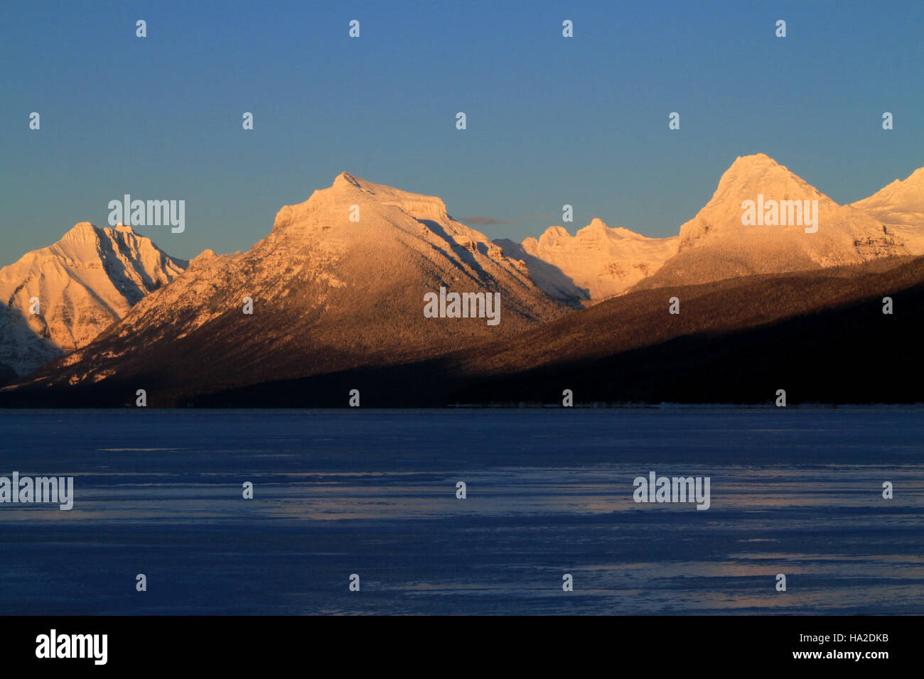 A stunning view of the Alpenglow phenomenon at Lake McDonald in Glacier ...