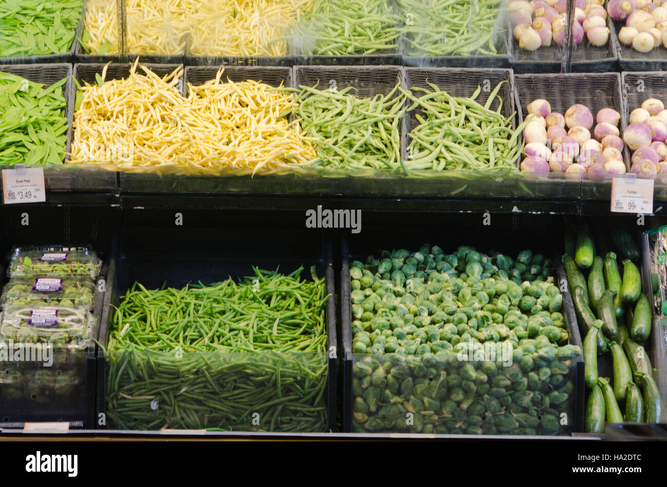 A grocery store display showcasing fresh vegetables like brussel ...