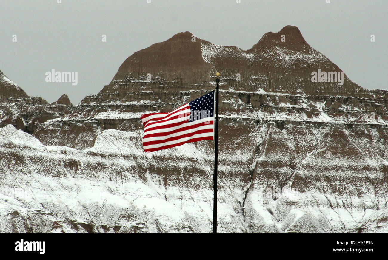 The image captures the stunning winter landscape of the Badlands with ...