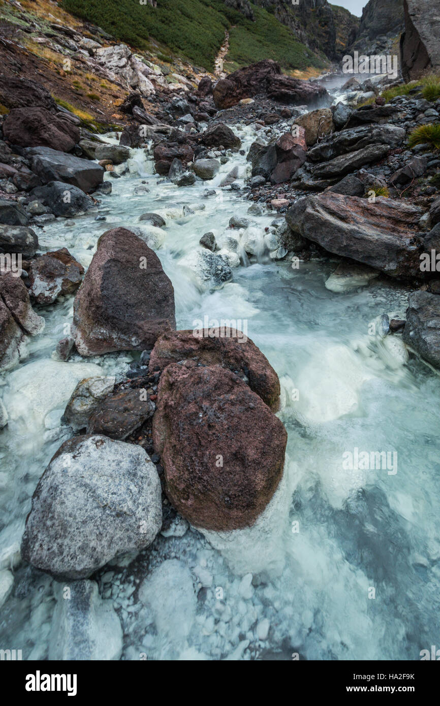 Yellow-white sulfuric mountain stream flowing from natural hot spring ...