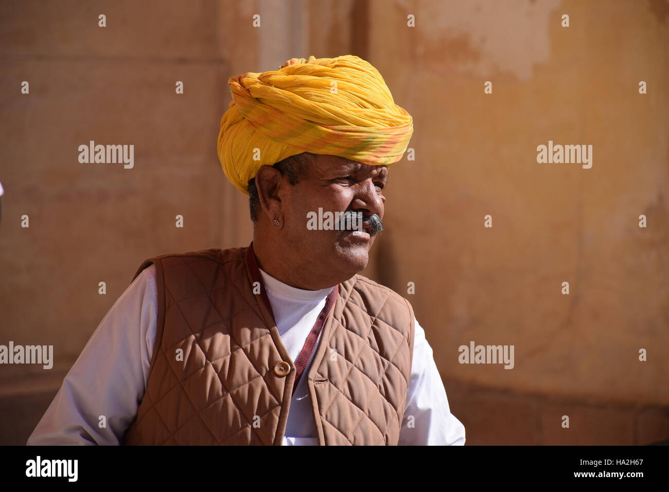 Indian man wearing a yellow turban inside Mehrangarh fort in Jodhpur ...