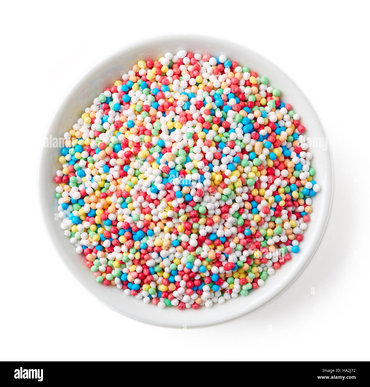 Colorful candy sprinkle dots in white bowl isolated on white background ...