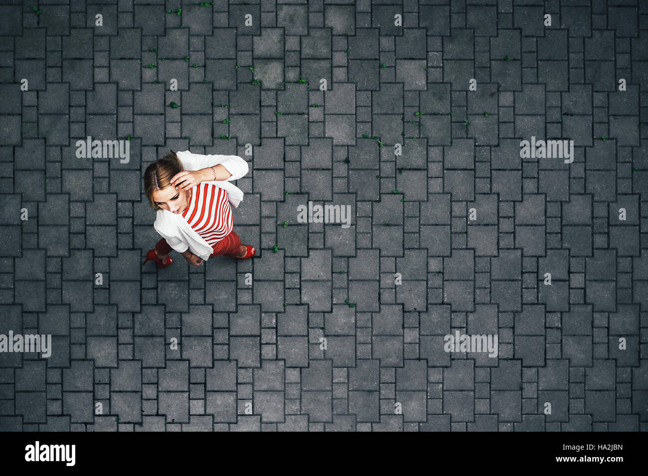 Overhead view of a young woman walking along street Stock Photo - Alamy