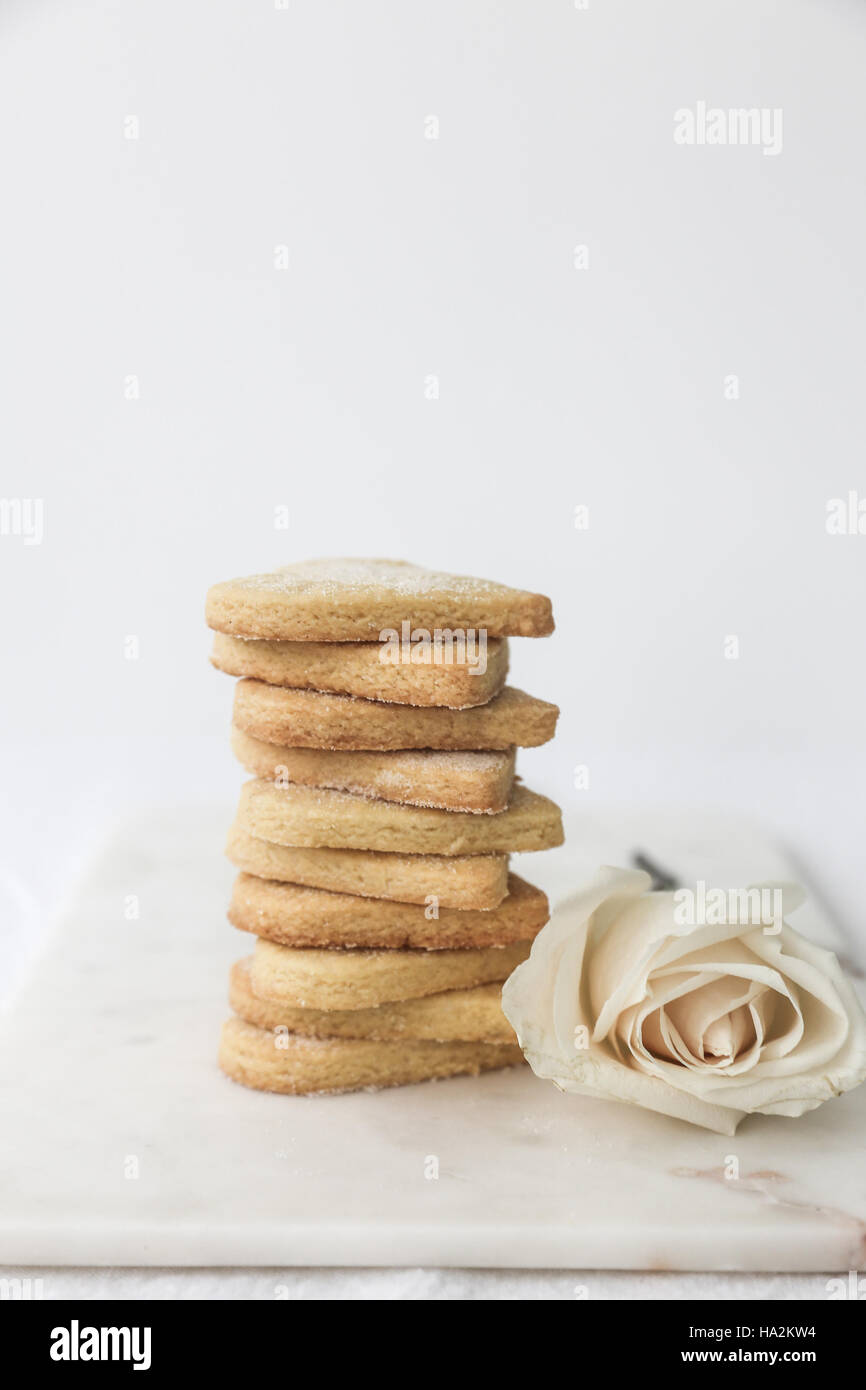 Stack of heart shaped shortbread biscuits and a rose Stock Photo - Alamy