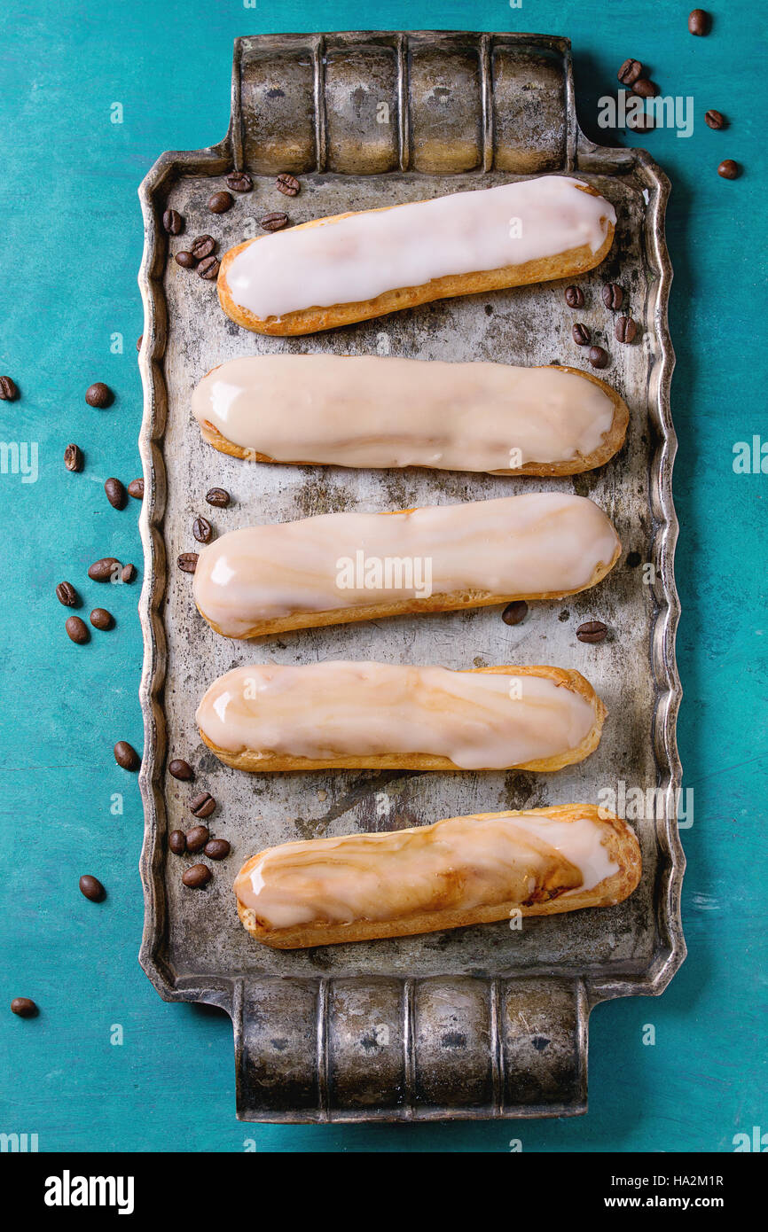 Coffee eclairs on vintage tray Stock Photo - Alamy