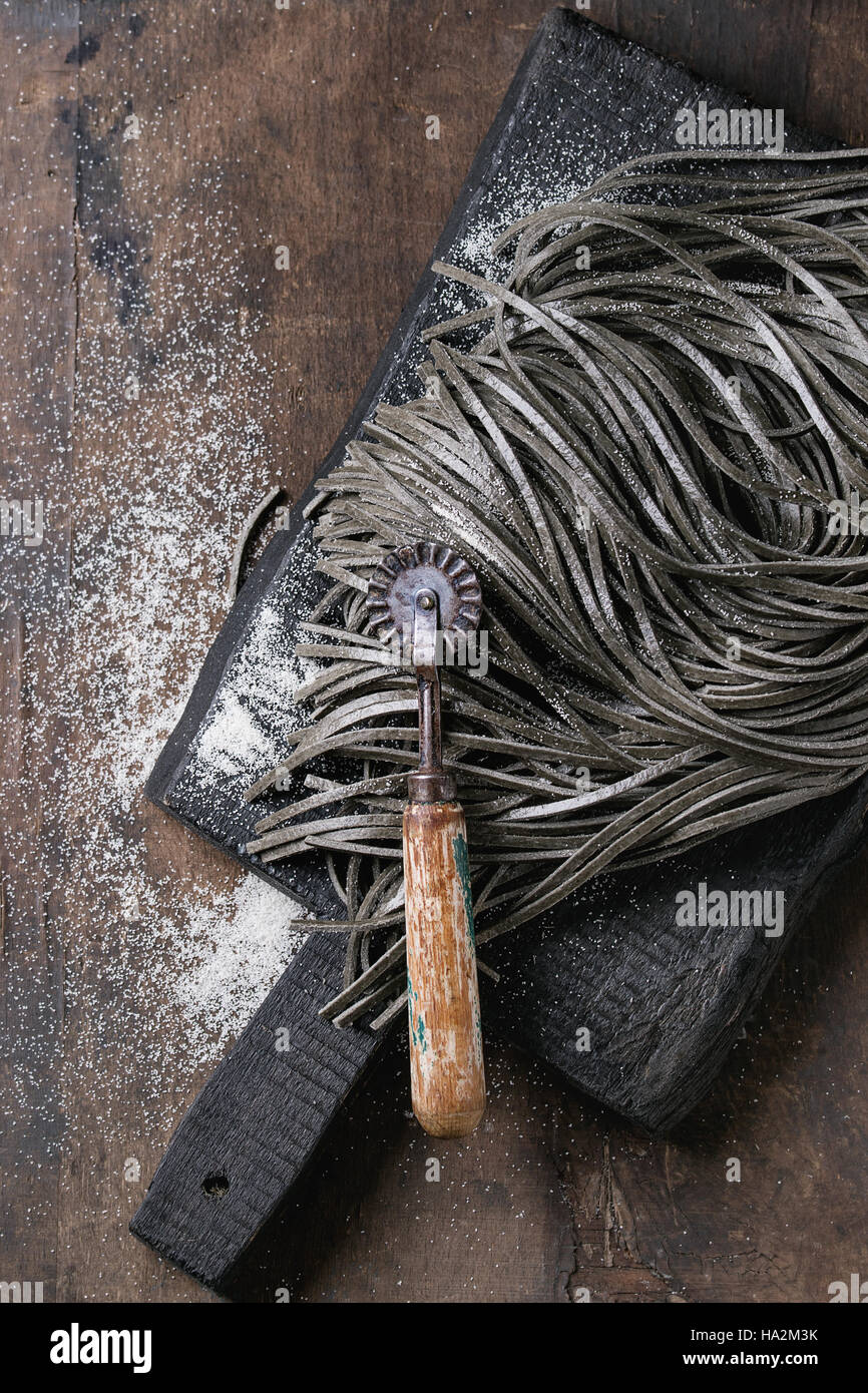 Raw black spaghetti pasta Stock Photo - Alamy