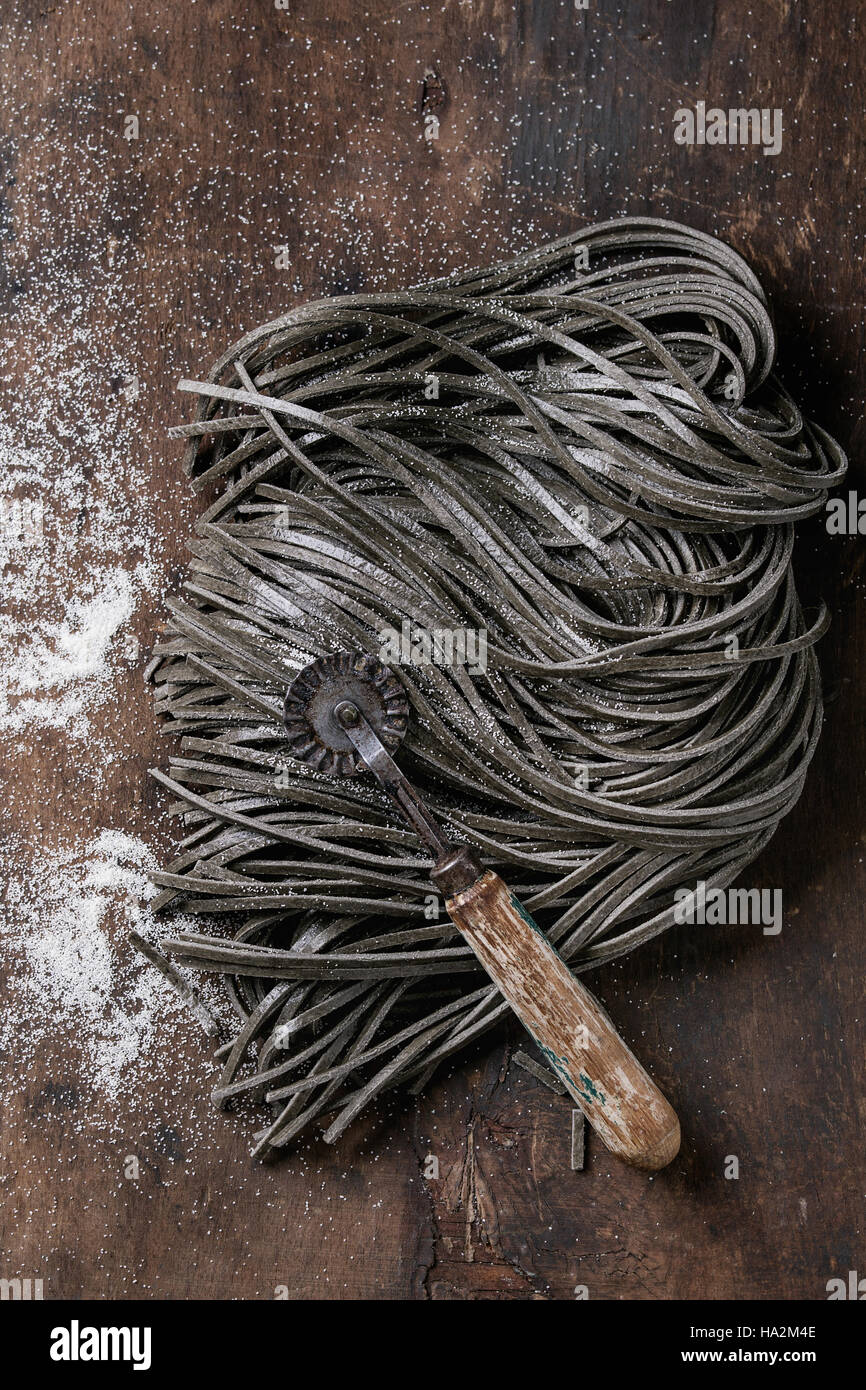 Raw black spaghetti pasta Stock Photo - Alamy