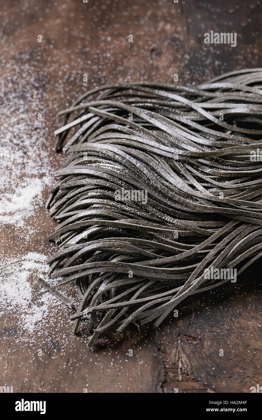 Raw black spaghetti pasta Stock Photo - Alamy
