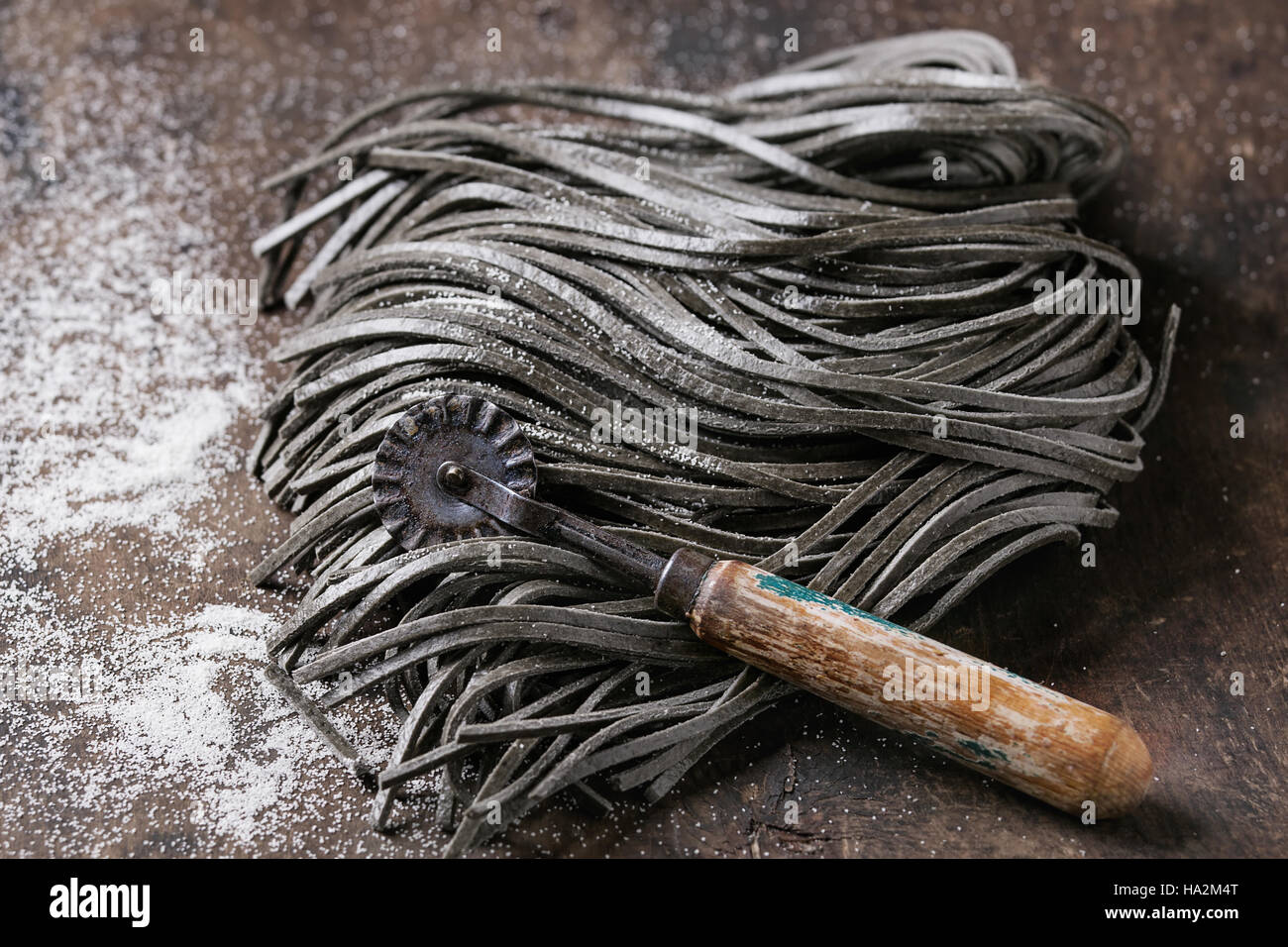 Raw black spaghetti pasta Stock Photo - Alamy