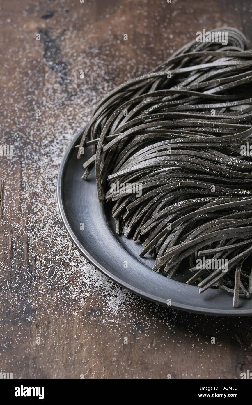 Raw black spaghetti pasta Stock Photo - Alamy