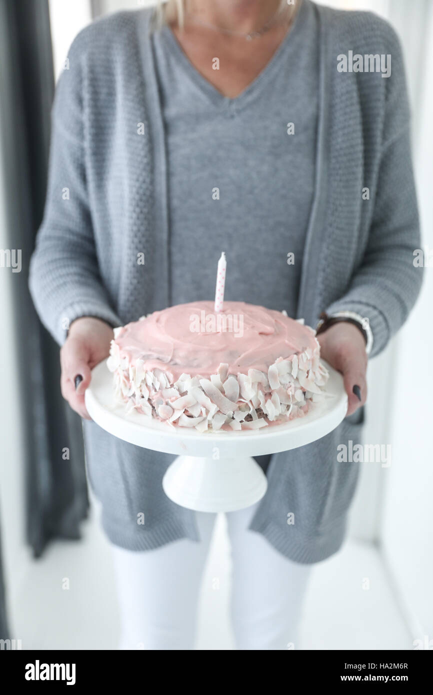 woman carrying birthday cake on a cake stand Stock Photo - Alamy