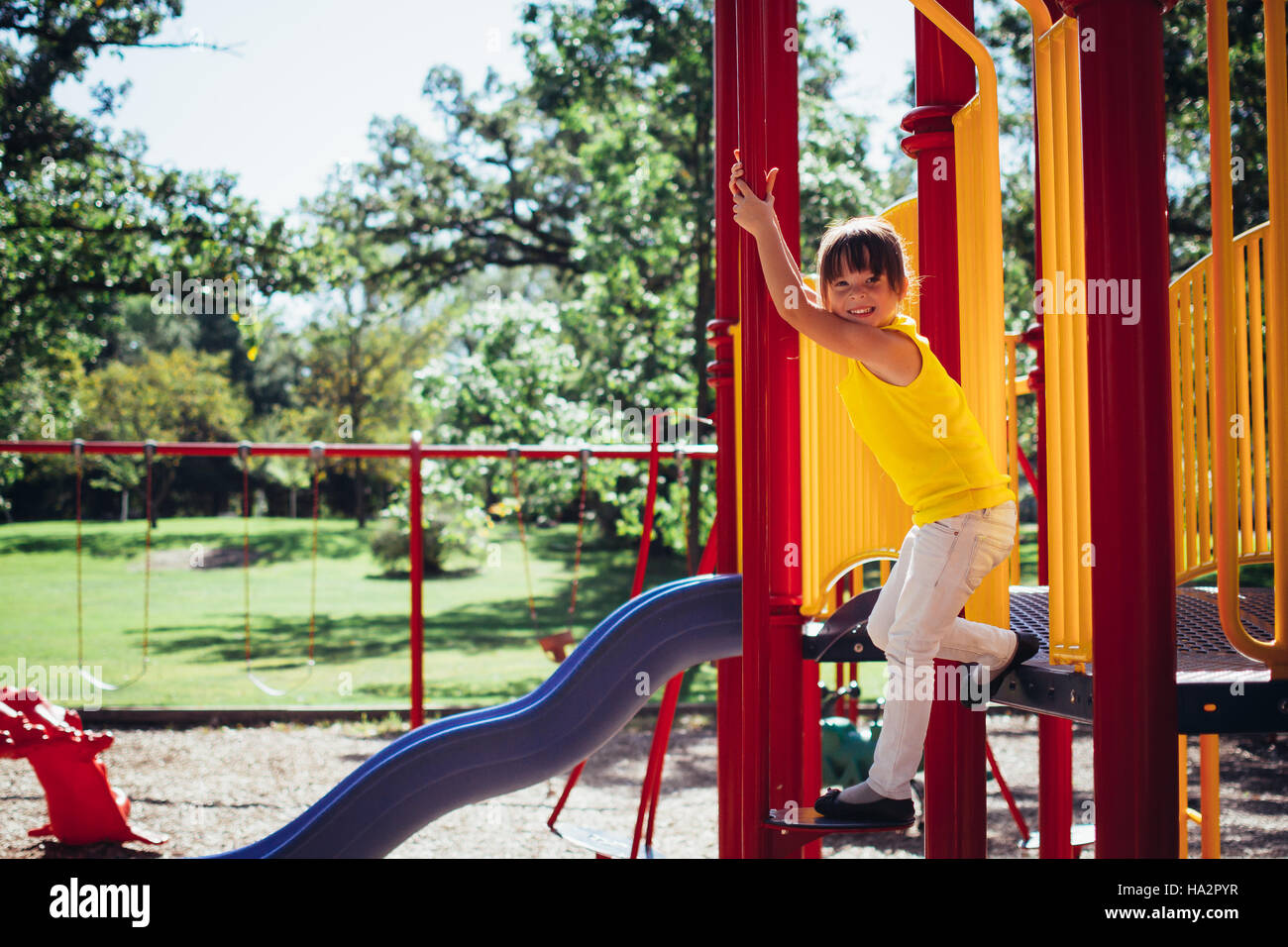 Girl climbing in playground hi-res stock photography and images - Alamy