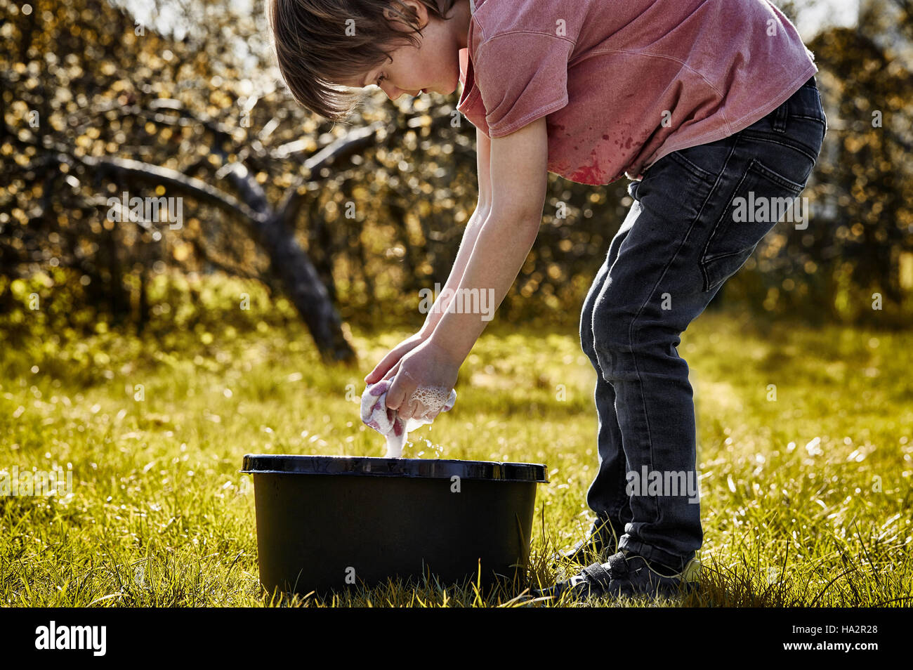 Boy washing his hands in a bowl of soap and water Stock Photo - Alamy