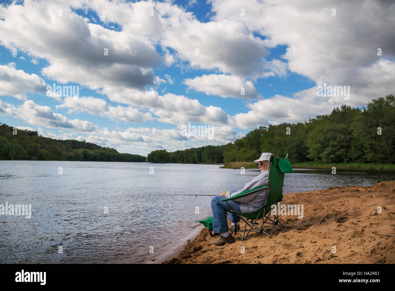 Man sitting in chair fishing hi-res stock photography and images - Alamy