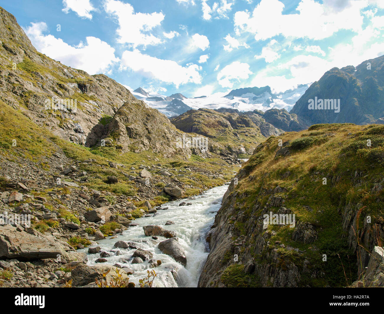 alpine mountain water stream in the mountain of Switzerland on a sunny ...