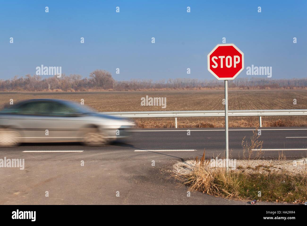 Stop Sign at Crossroads. Rural road. Exit onto the main road. Main road ...