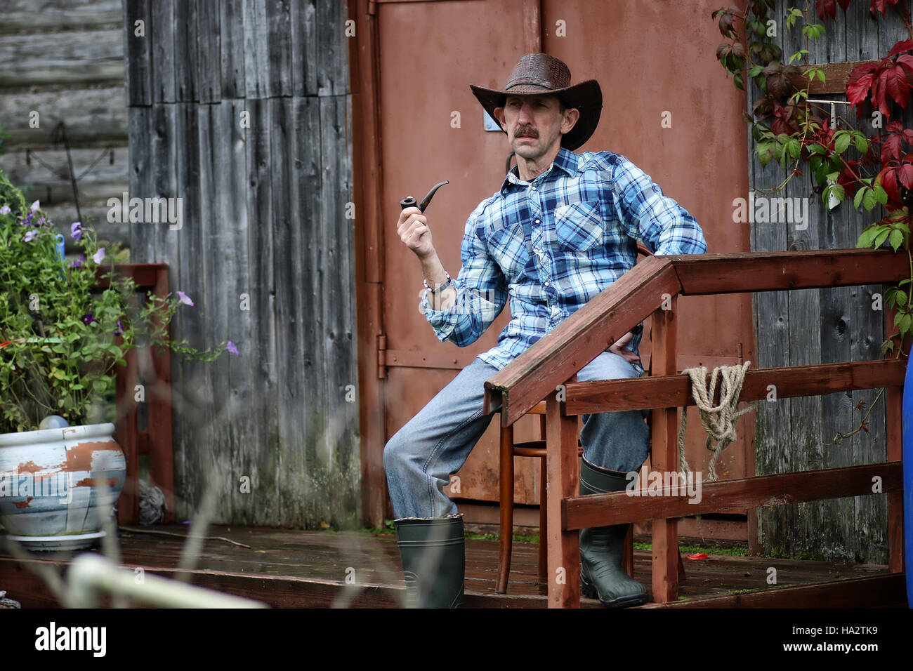 cowboy man smoke pipe Stock Photo - Alamy