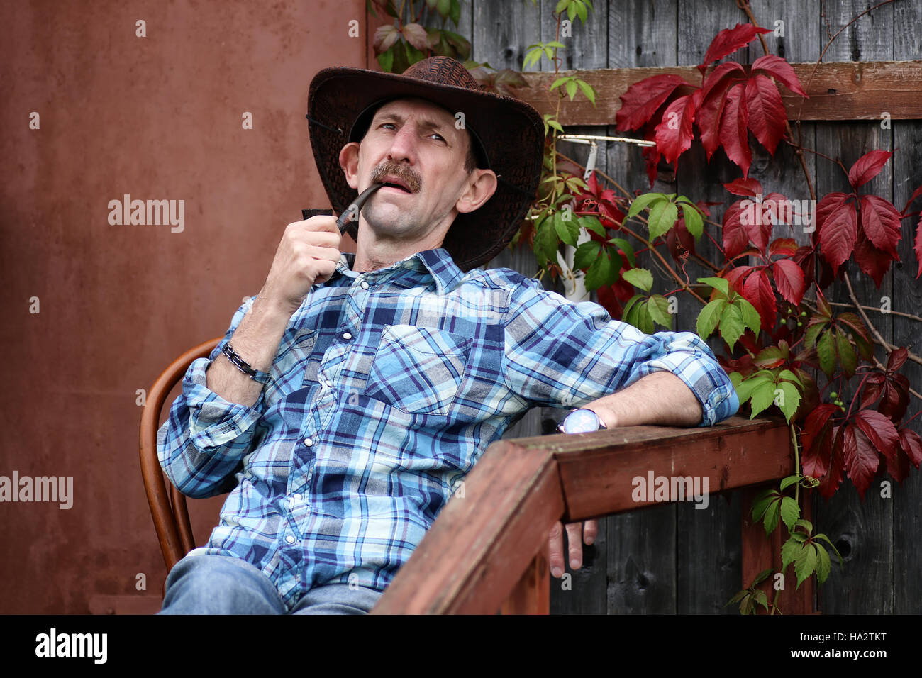 cowboy man smoke pipe Stock Photo - Alamy