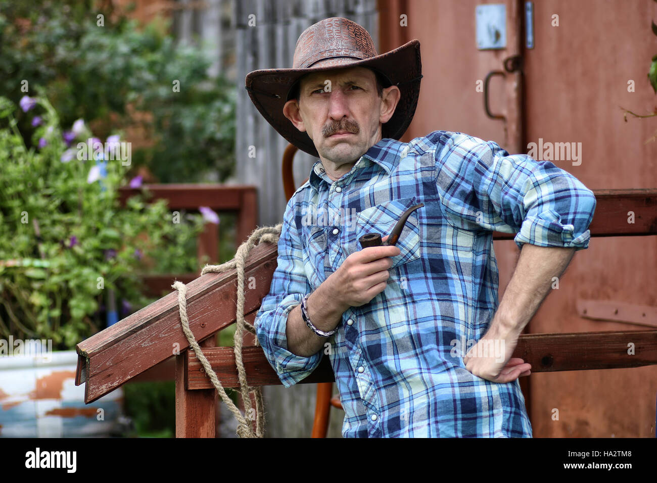 cowboy man smoke pipe Stock Photo - Alamy