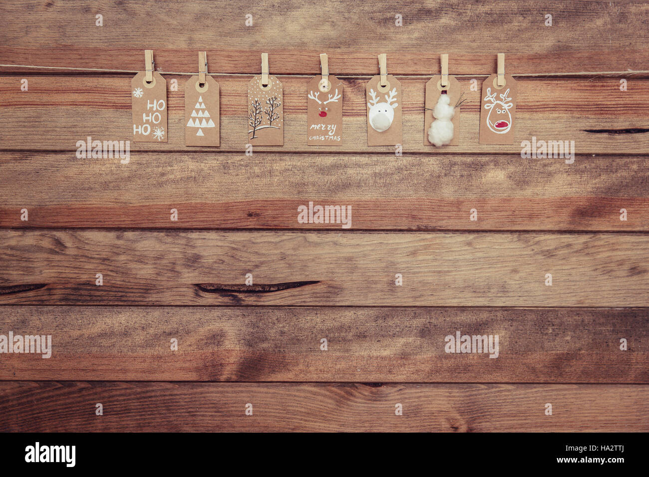 Christmas gift tags hanging on piece of string Stock Photo - Alamy