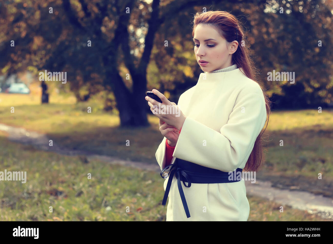 girl in a park walk autumn alone Stock Photo - Alamy