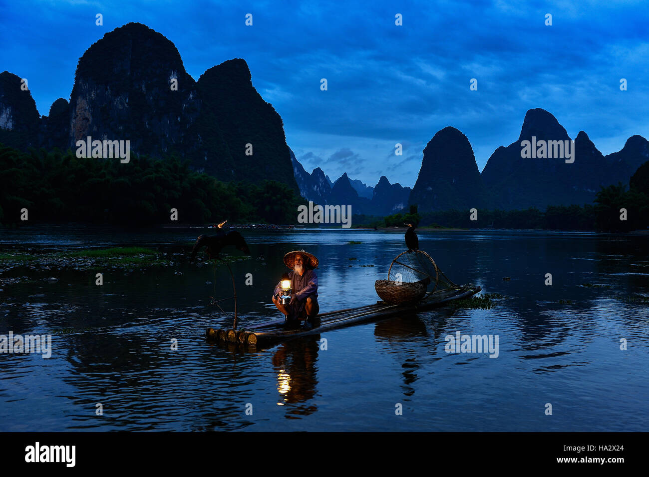 Fisherman on raft on Li river at night, Guilin, Guangxi, China Stock ...