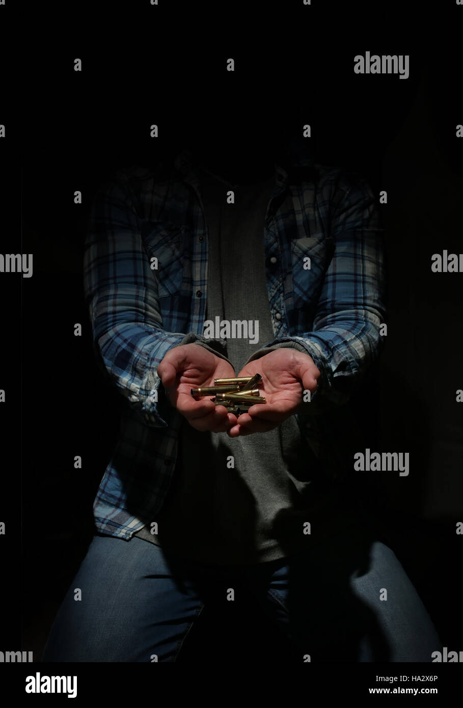 bullet in hands man Stock Photo - Alamy