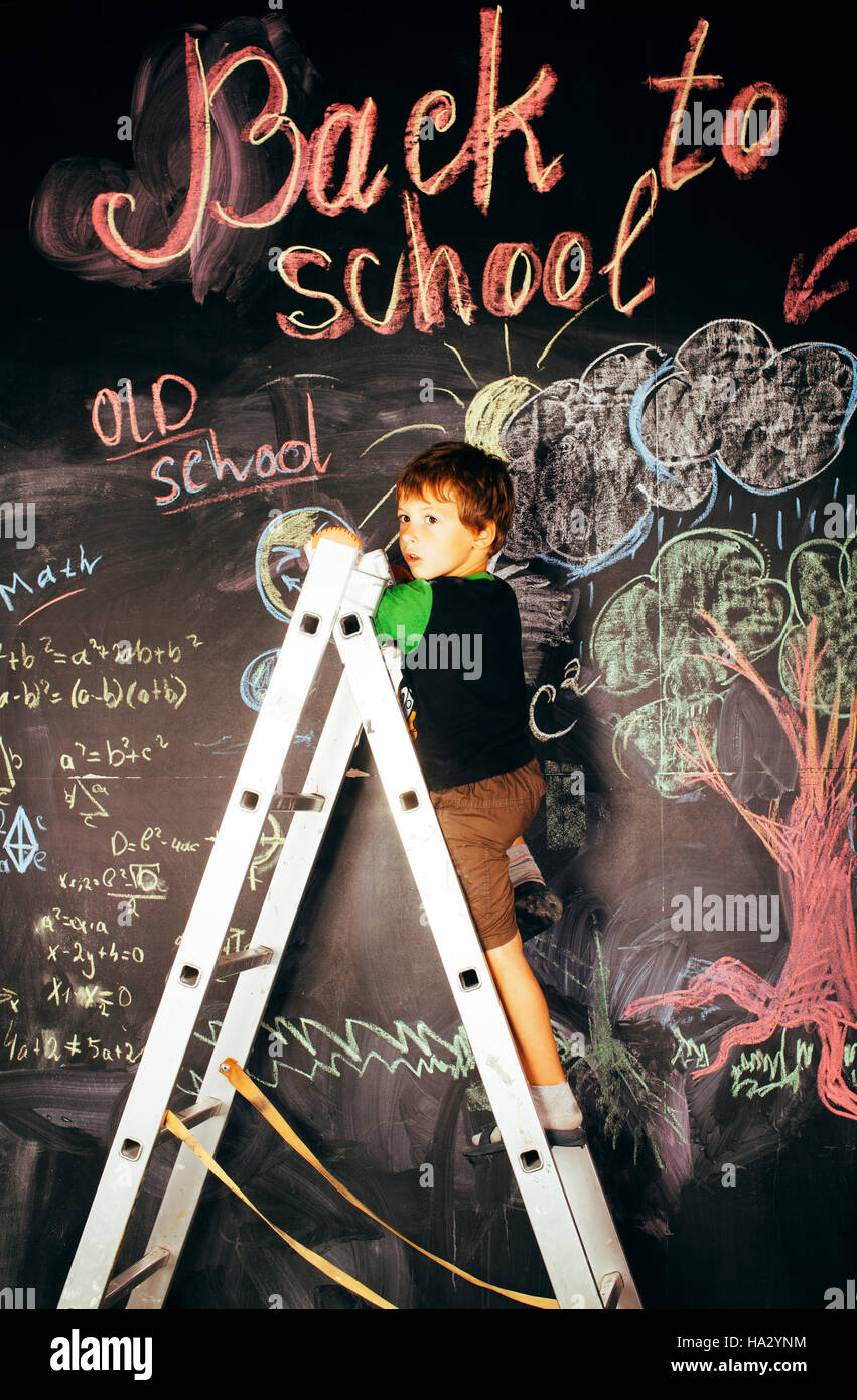 little cute real boy at blackboard in classroom, back to school Stock ...