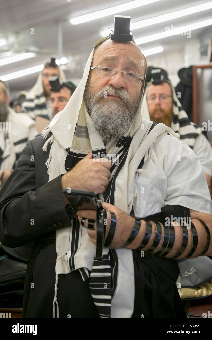 A Jewish rabbi in deep thought at morning prayers at a synagogue at the ...