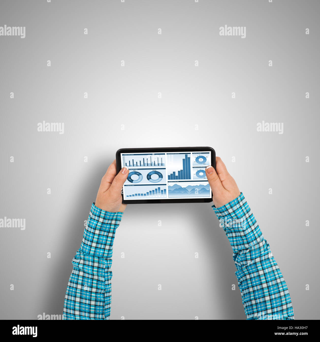 Top view of girl hands using tablet pc with diagrams and graphs on ...