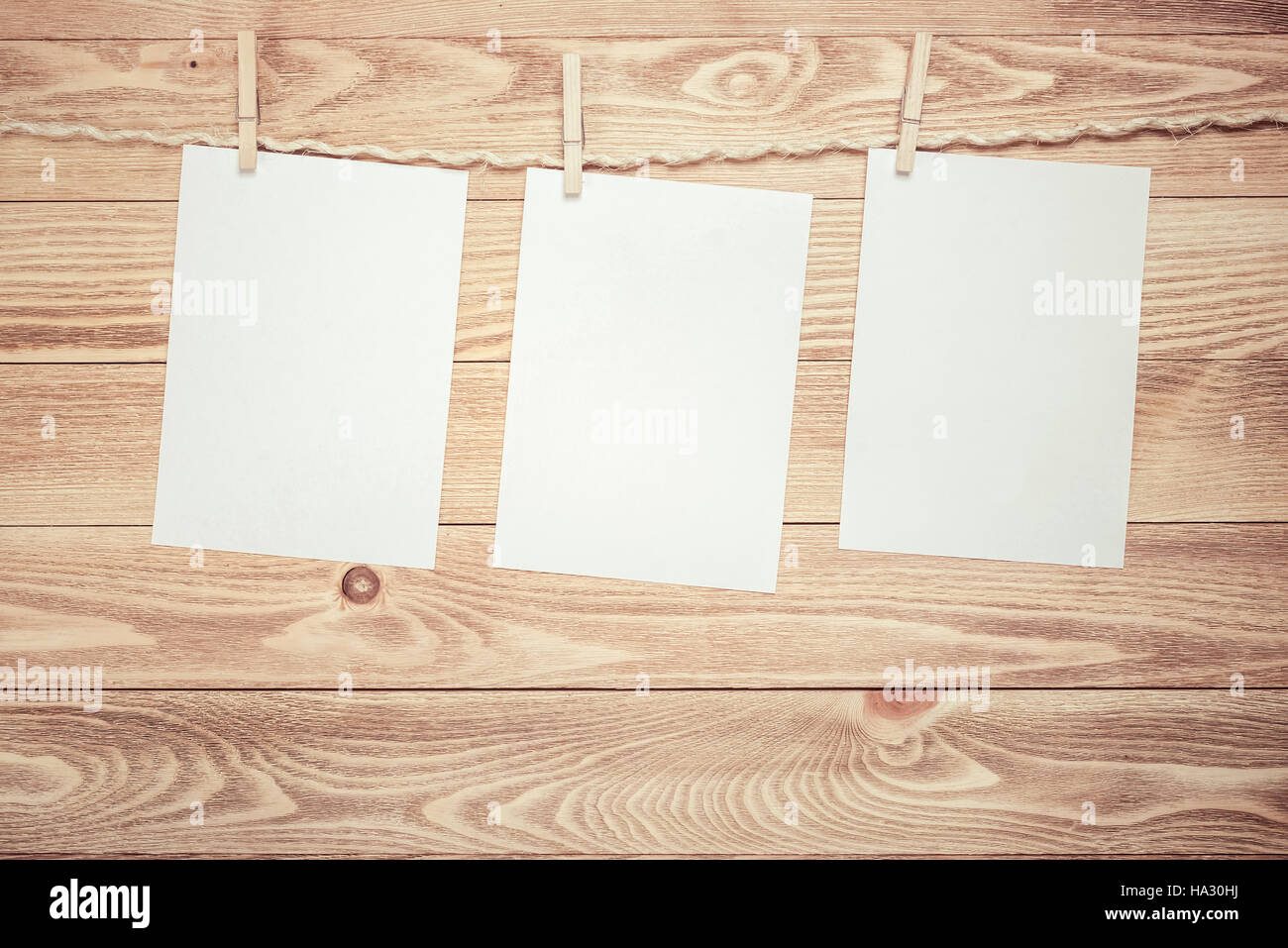 Blank paper sheets for text hanging on rope Stock Photo - Alamy