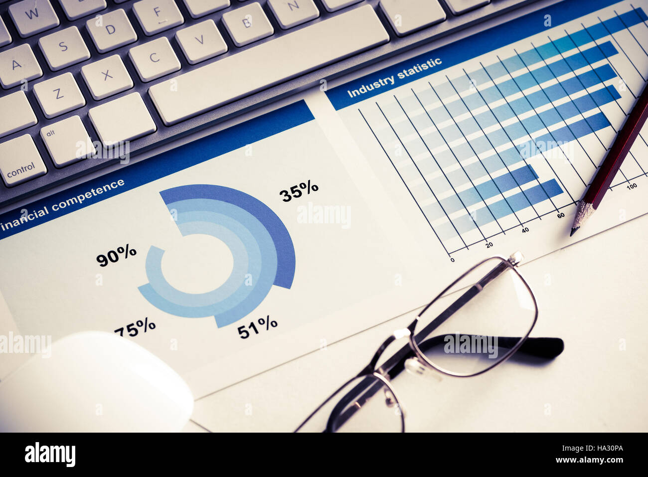 Business workplace with keyboard mouse and papers with graphs and ...